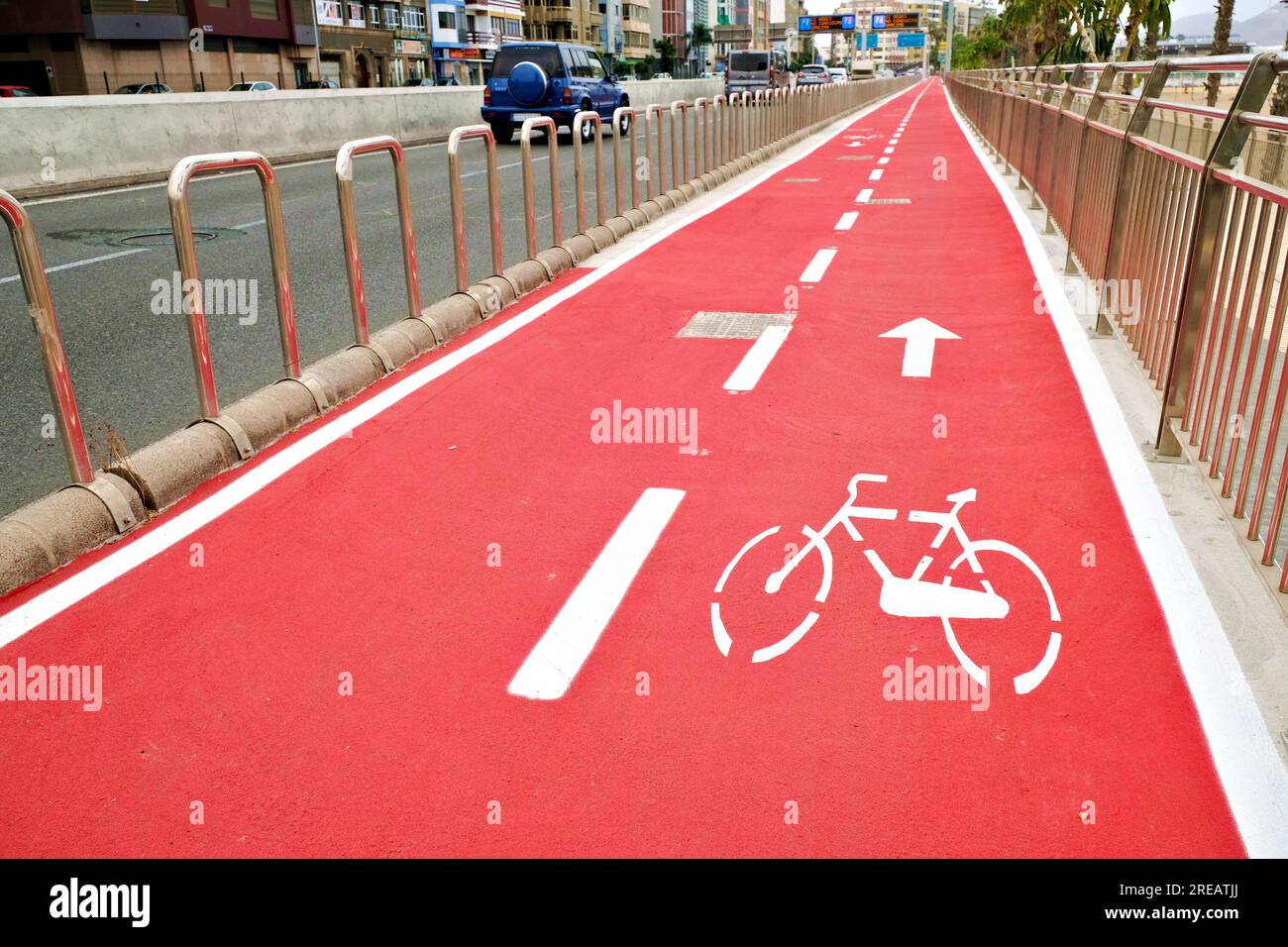 Bright red biking lanes clearly marked with biking symbol in stencil ...