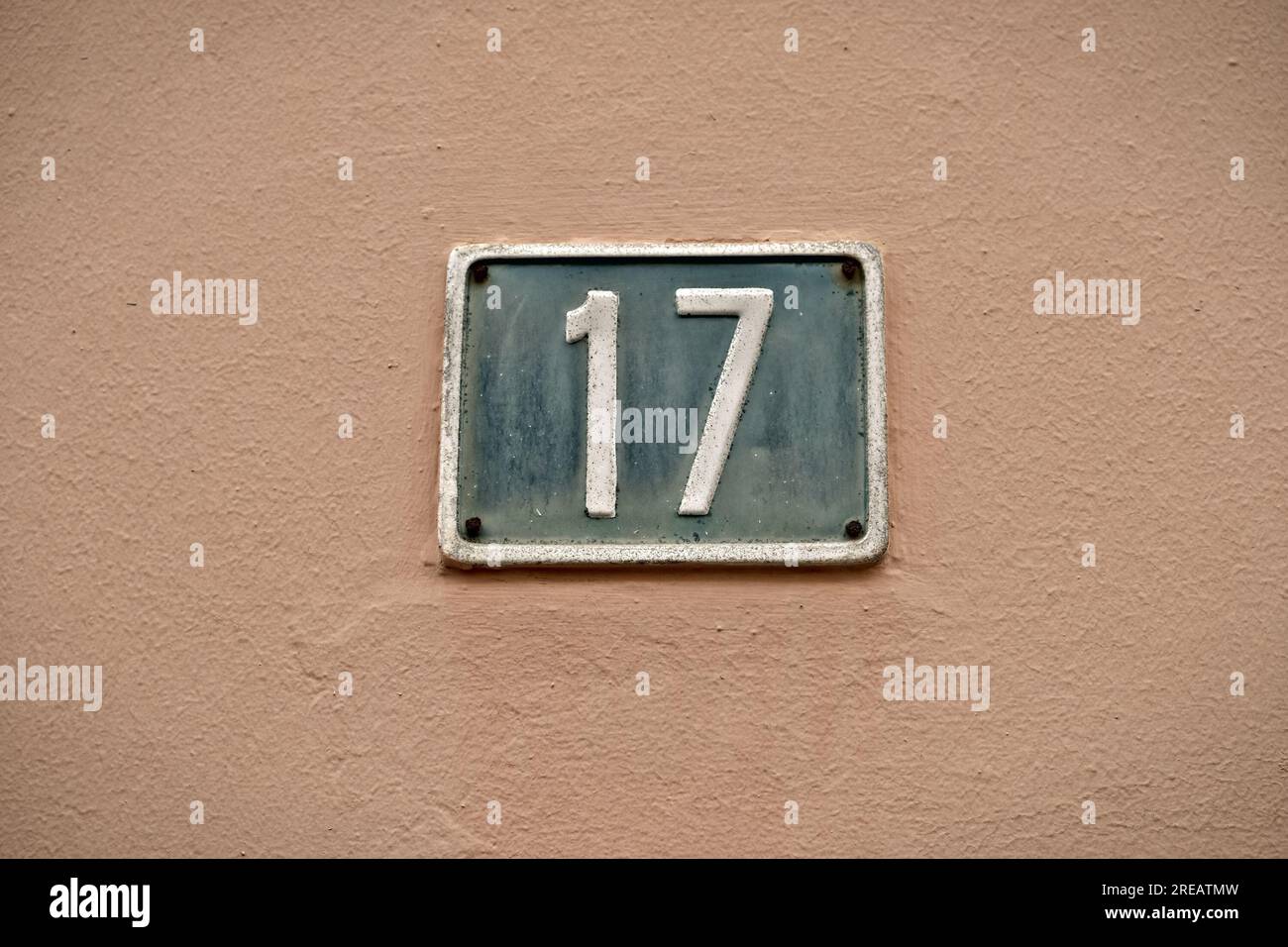Number 17, seventeen, blue plate on subdued pink background Stock Photo ...