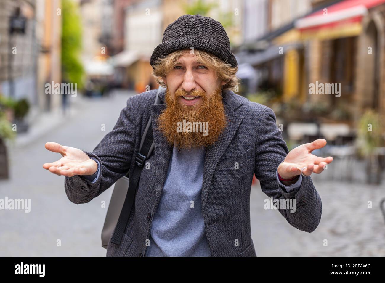 What. Why. Surprised frustrated young bearded man raising hands asking ...