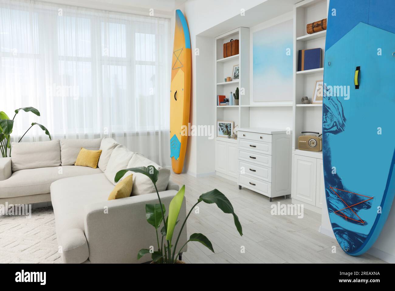 SUP boards, shelving unit with different decor elements and stylish ...