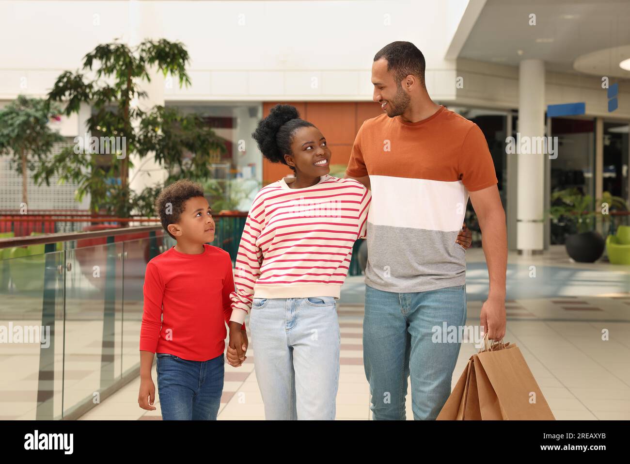 Family shopping. Happy parents and son with purchases in mall Stock ...
