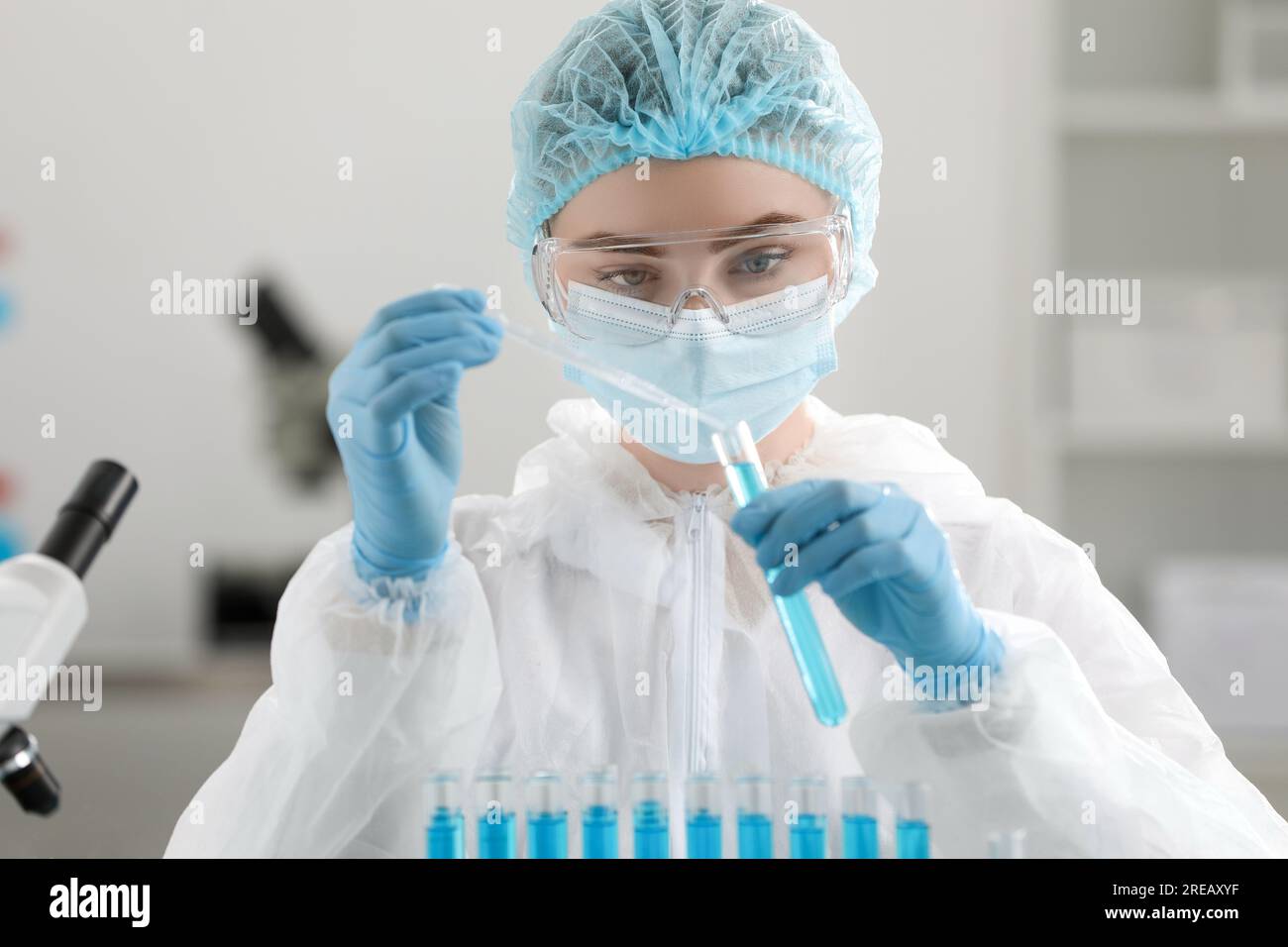 Scientist dripping sample into test tube in laboratory Stock Photo - Alamy