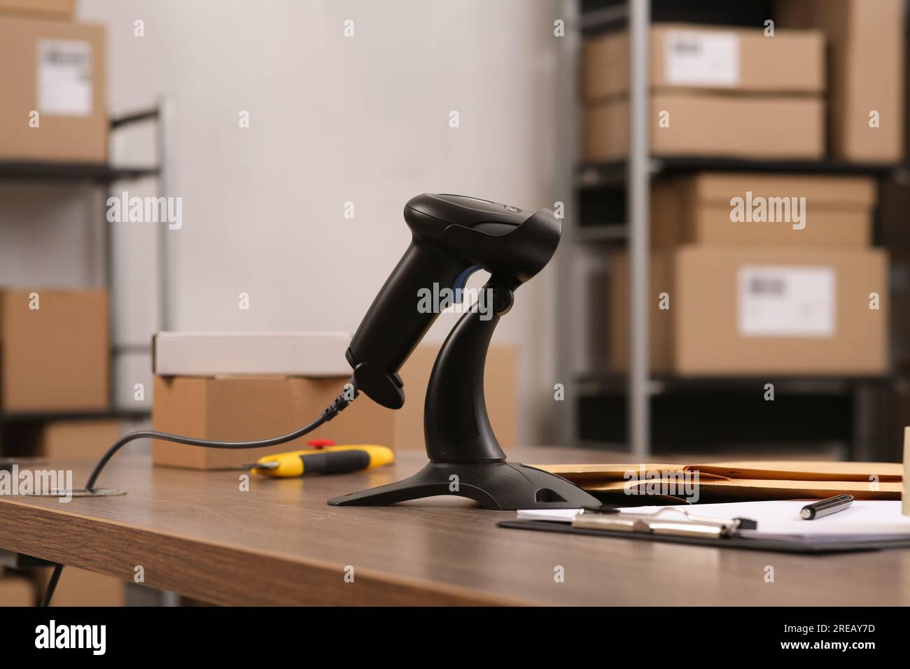 Black modern barcode scanner on wooden table in office. Online store ...