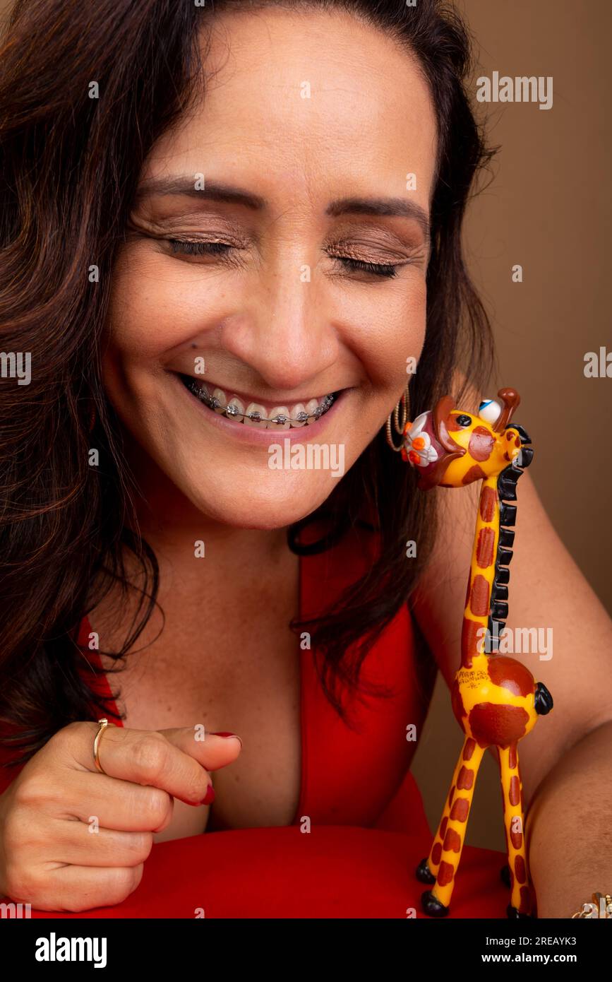 Cheerful coaching woman with a giraffe puppet. Symbol of non-violent ...