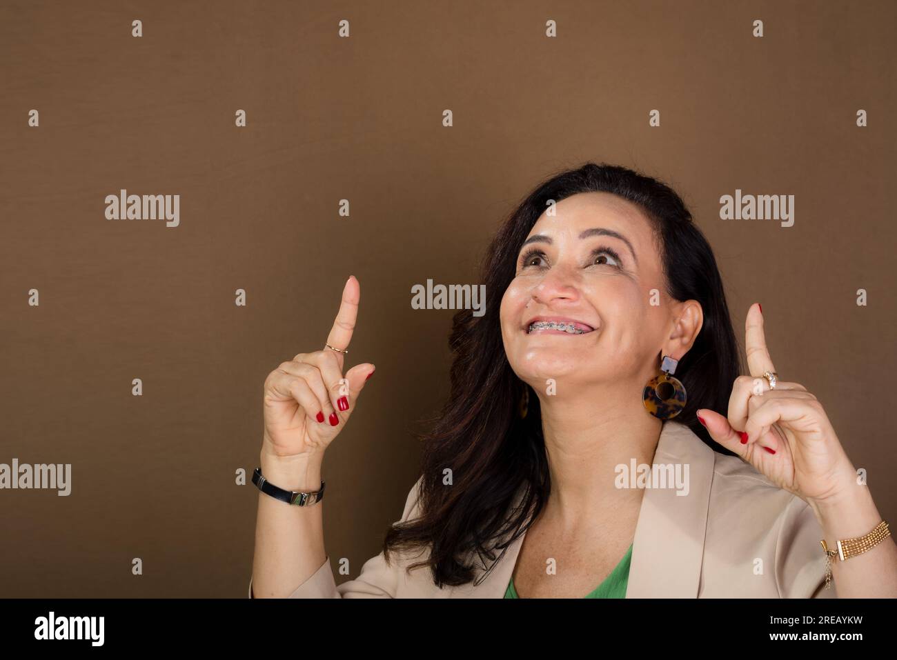 Portrait smiling and confident coaching woman making hand gestures ...