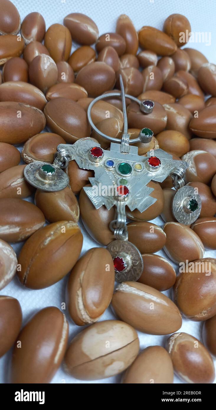 An Amazigh fibula (Tazerzit) over the beads of the Argan Stock Photo ...