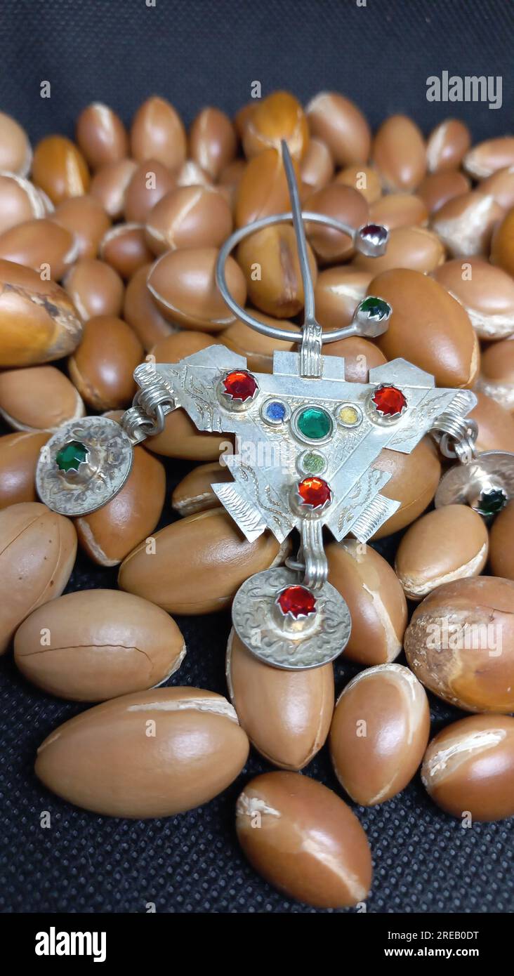 An Amazigh fibula (Tazerzit) over the beads of the Argan Stock Photo ...