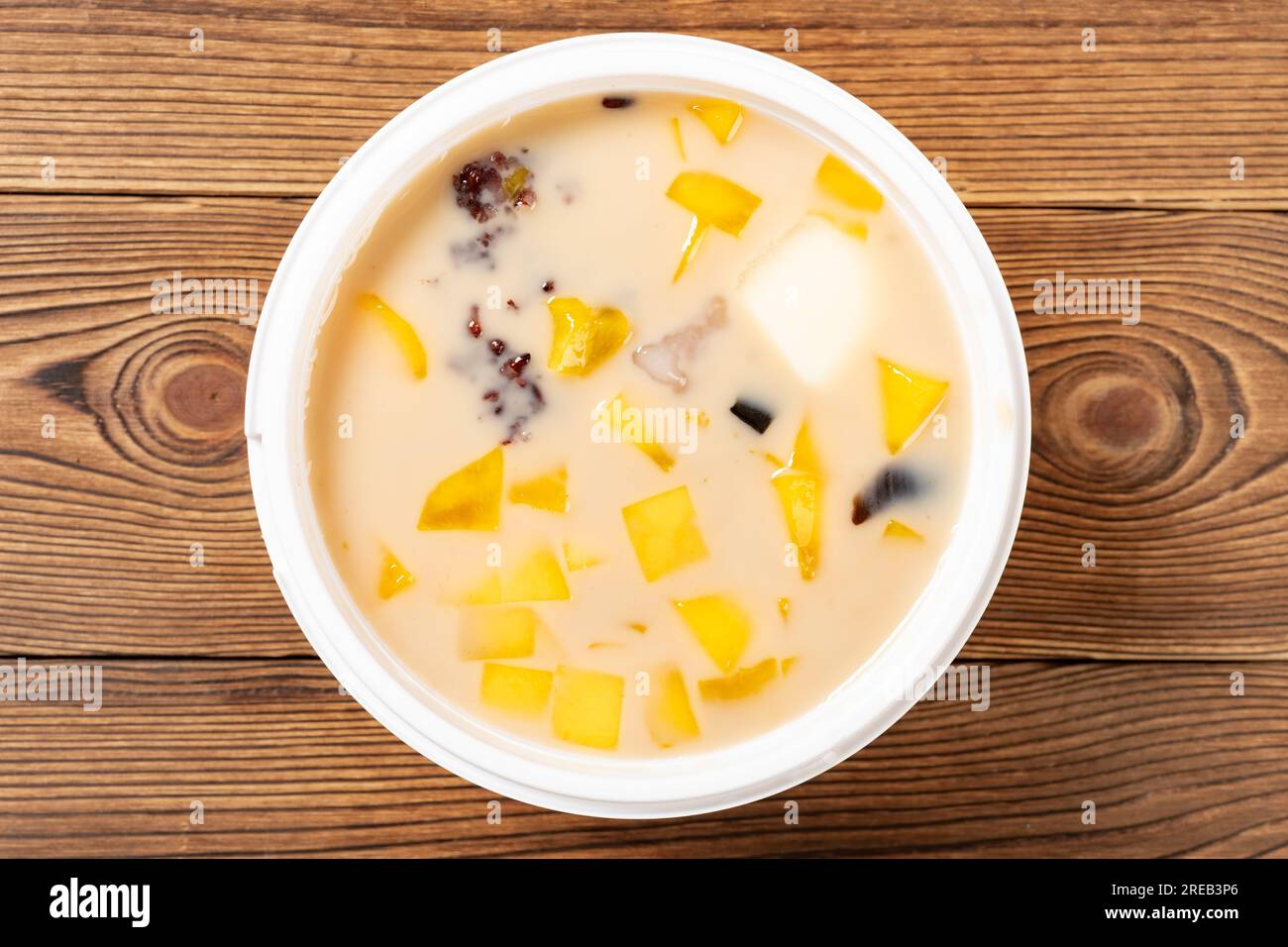 top view bowl of milktea flavor syrup mixed with grass jelly and ...