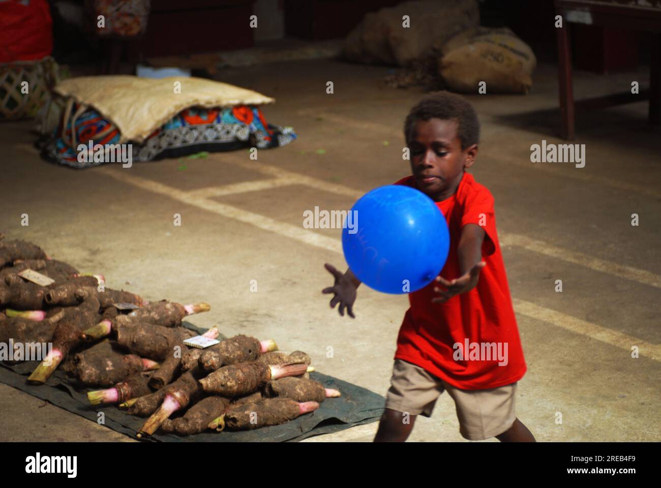 Boy playing with a blue balloon, Port Vila Markets, Port Via, Vanuatu ...