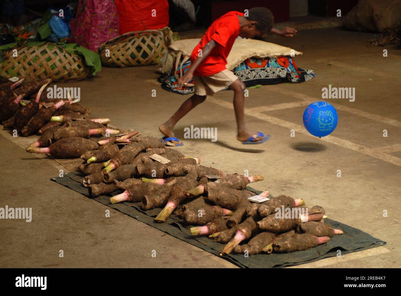 Boy playing with a blue balloon, Port Vila Markets, Port Via, Vanuatu ...
