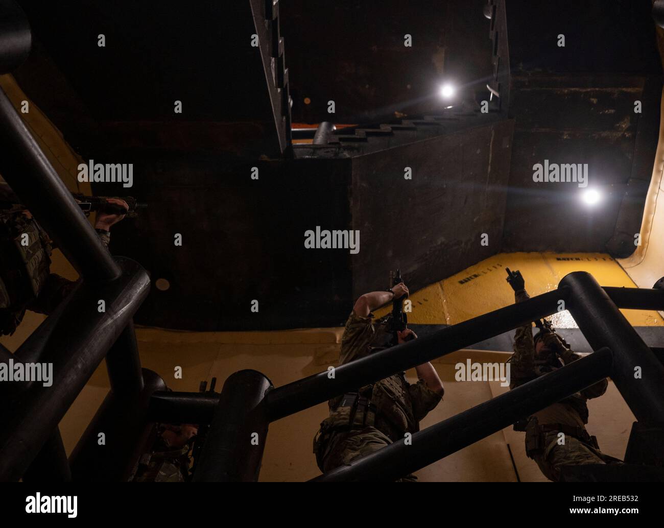 Operators from a U.S. Naval Special Warfare unit clear a stairwell ...