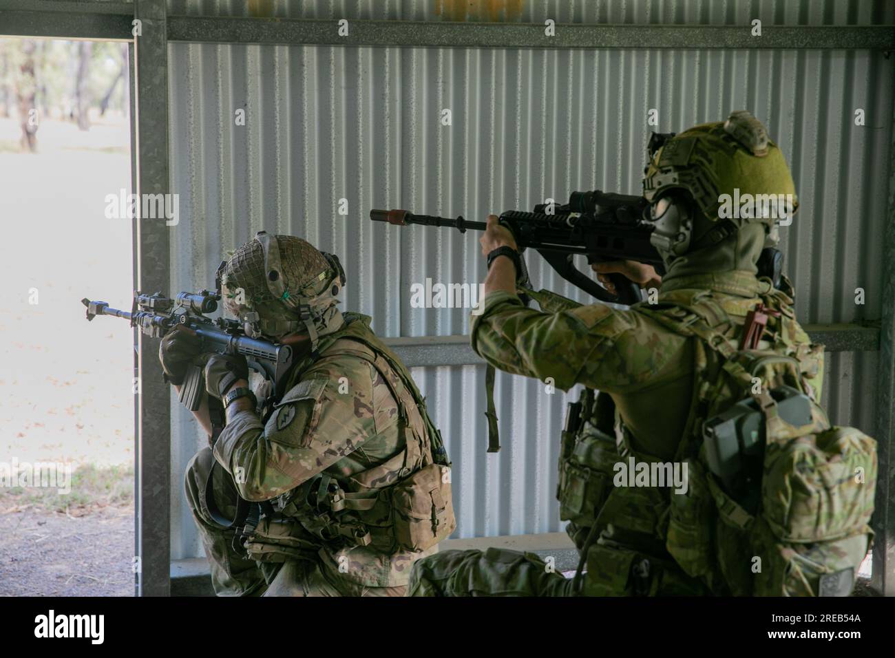 U.S. and Australian Army Soldiers pull security while waiting for ...