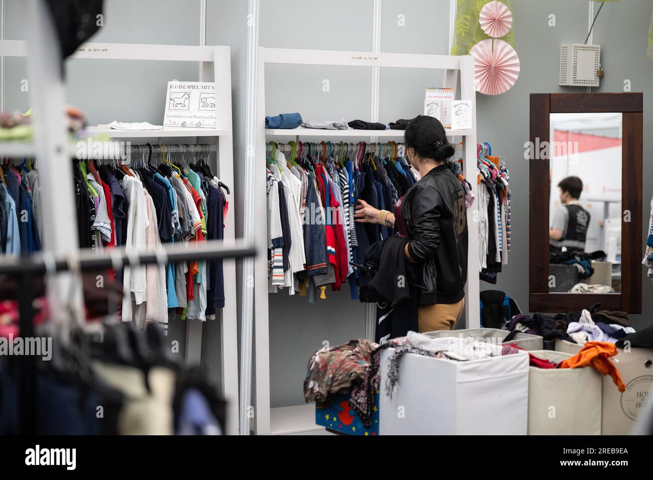 Berlin, Germany. 26th July, 2023. A woman picks out clothes in the so ...