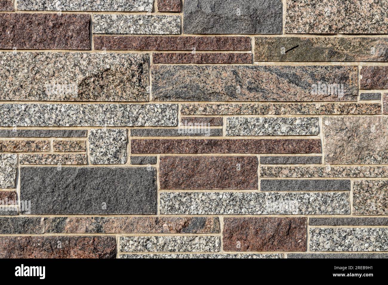 Full frame texture background of a modern granite stone wall in ashlar ...