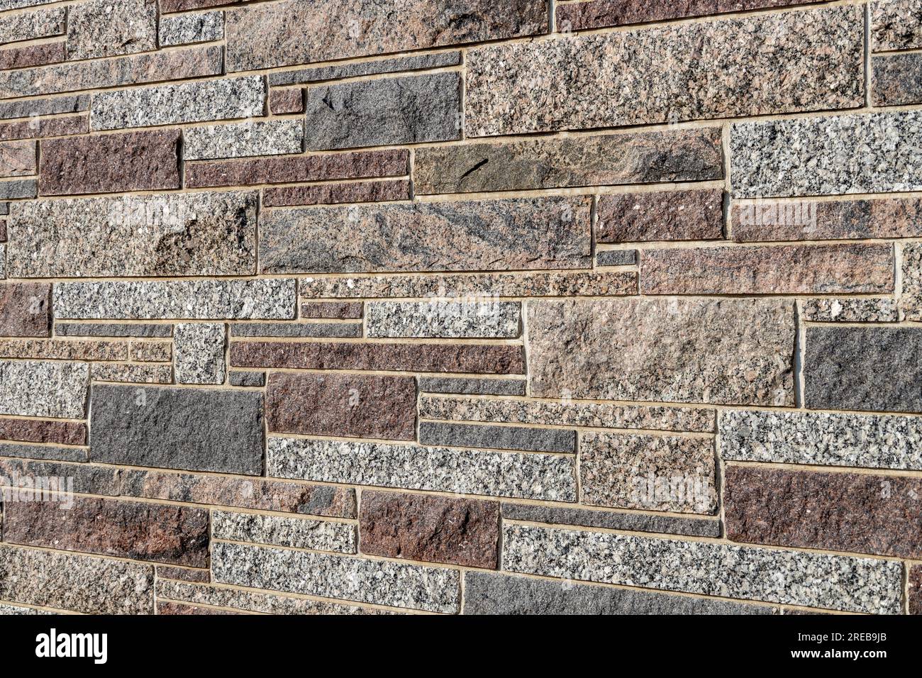 Full frame texture background of a modern granite stone wall in ashlar ...