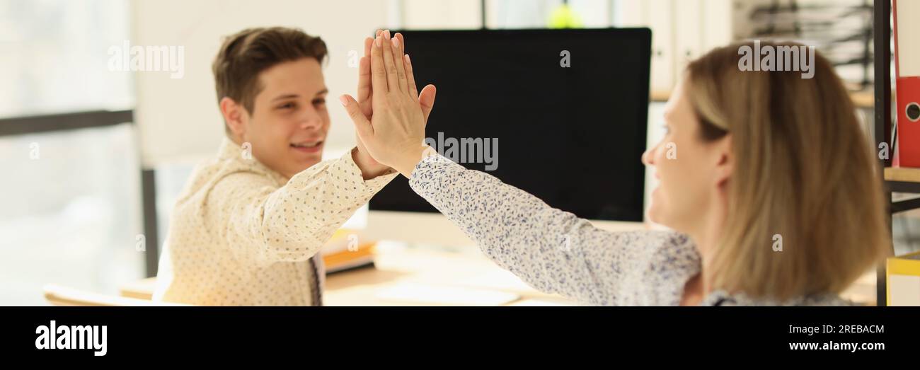 Happy business partners high five in office closeup Stock Photo - Alamy