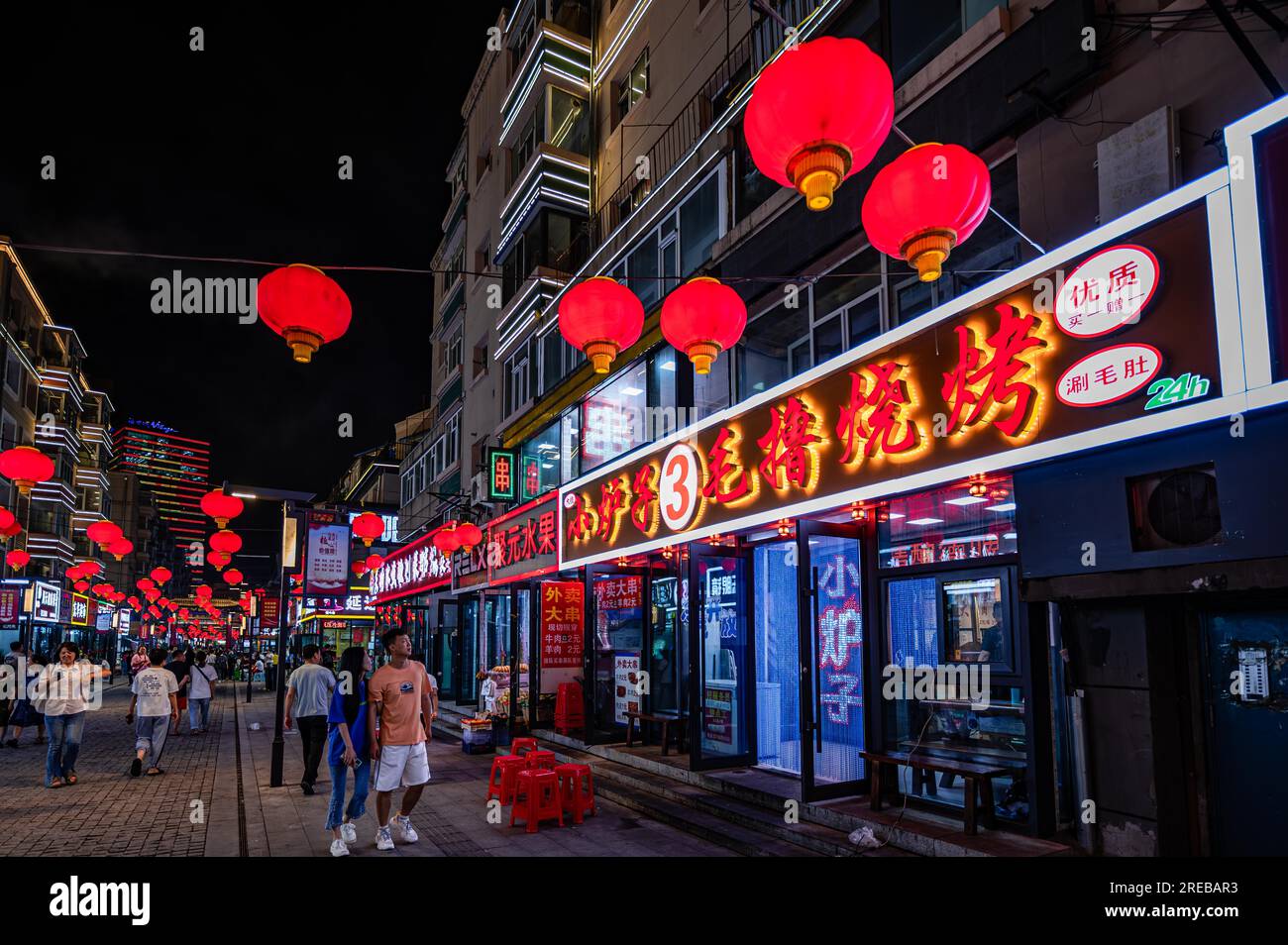 People visit the Chongqing hutong street at night in Changchun City ...