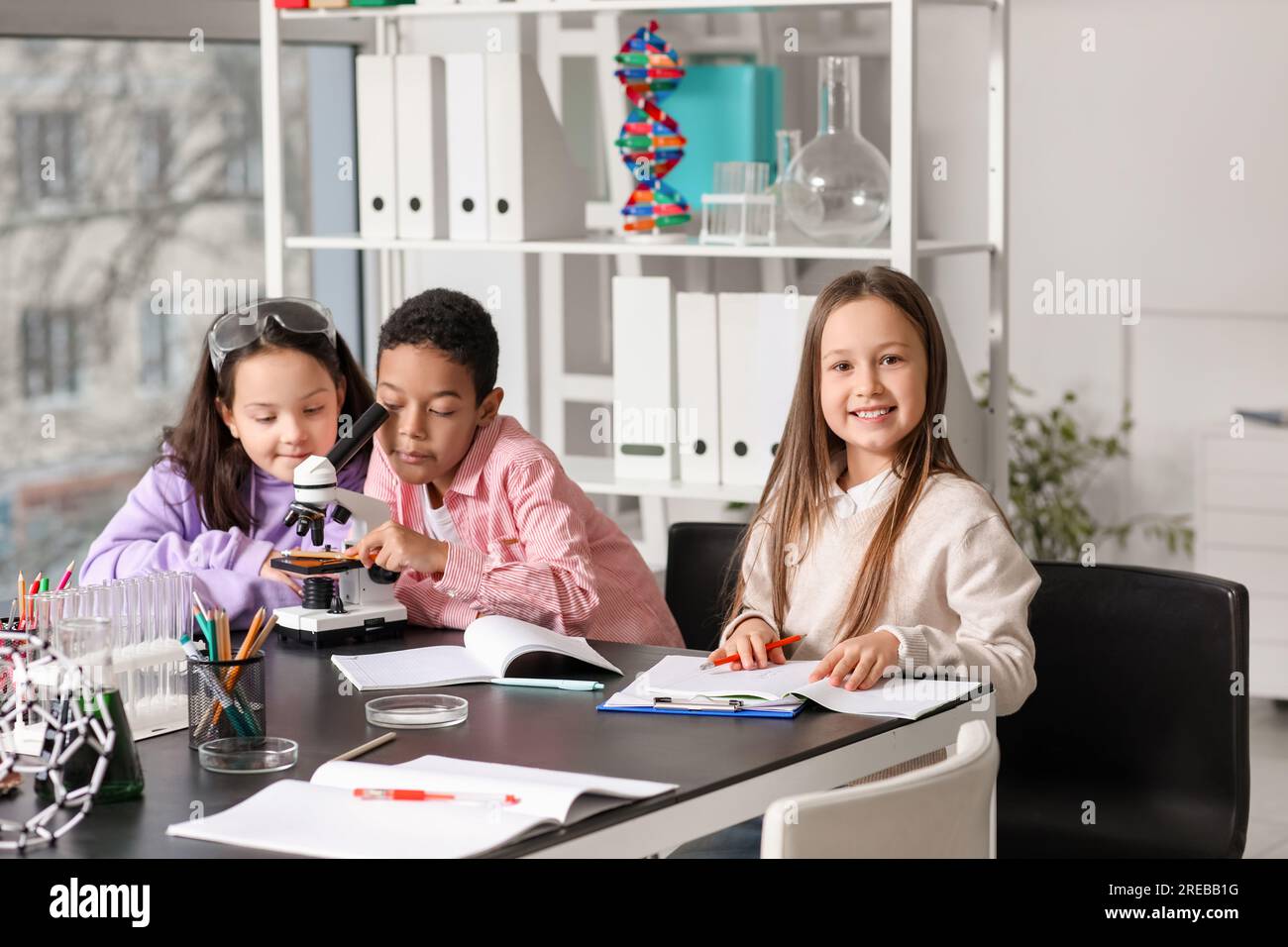 Little children with molecules studying Chemistry in science classroom ...