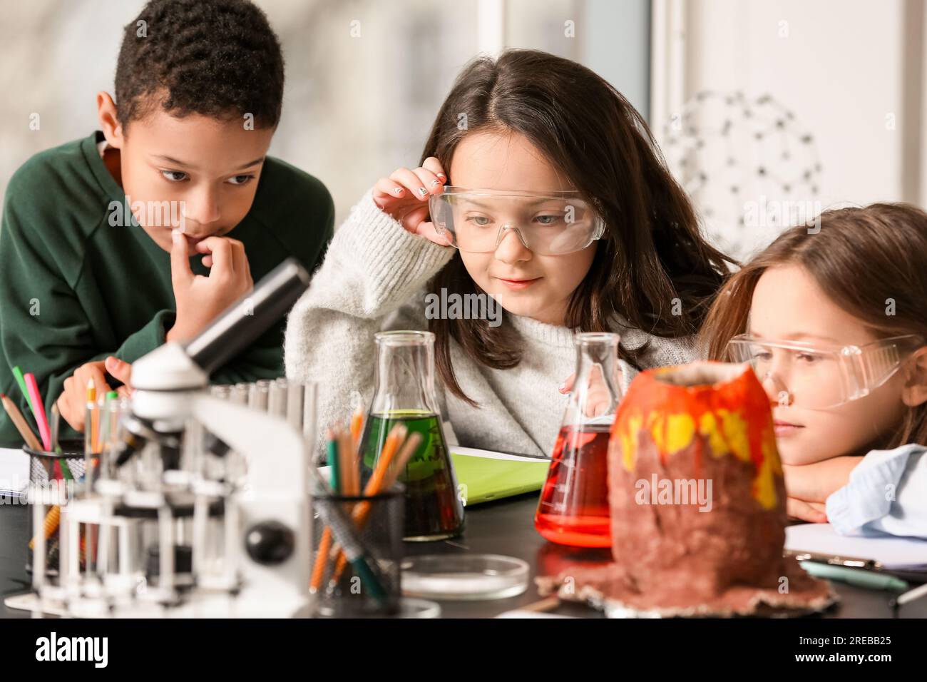 Little children conducting chemistry experiment in science classroom ...