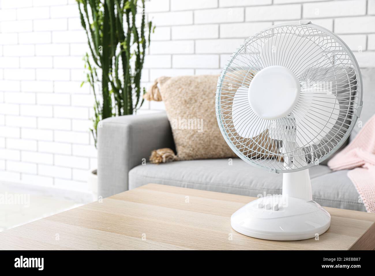 Modern electric fan on table in living room Stock Photo - Alamy