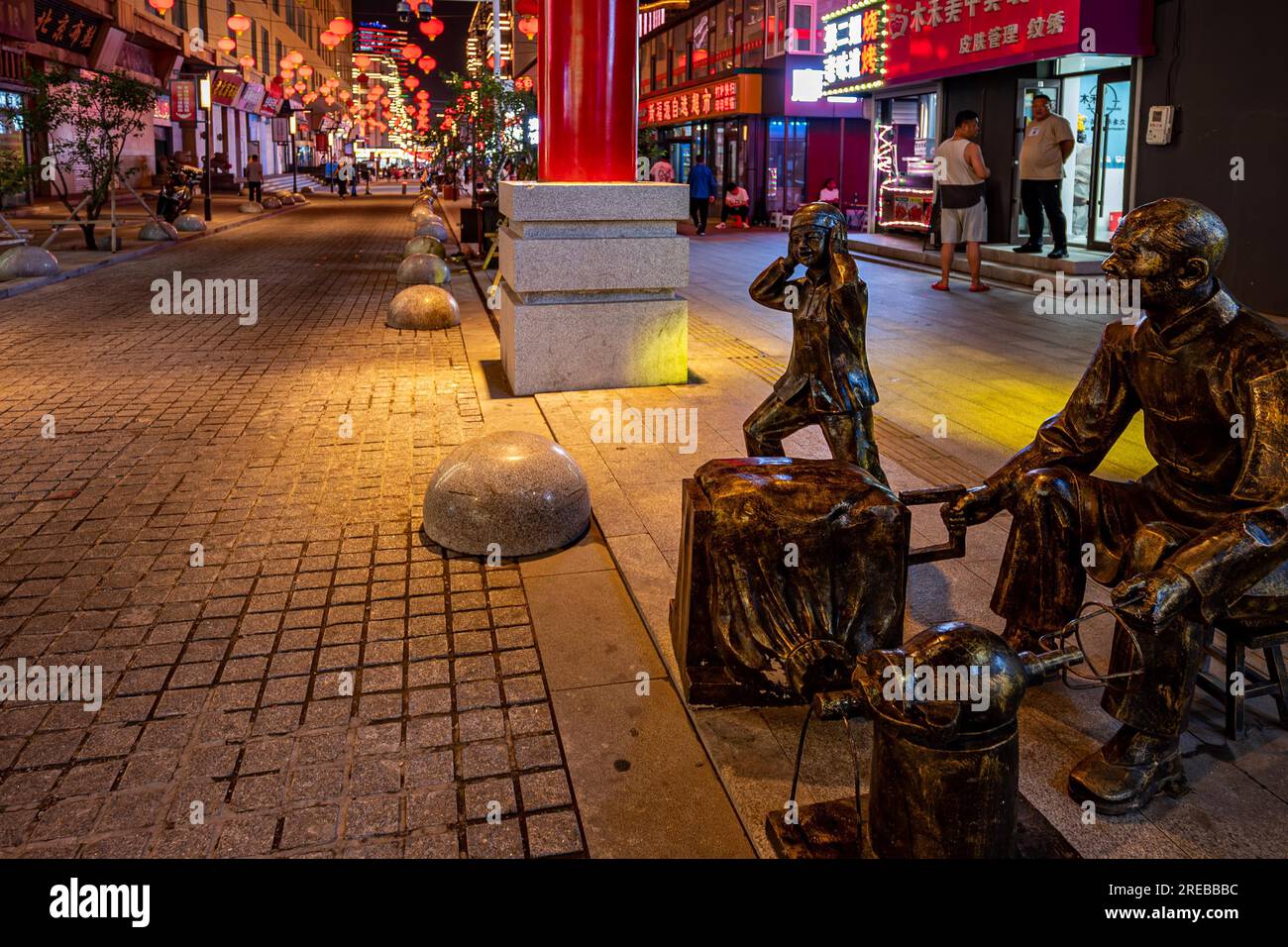 People visit the Chongqing hutong street at night in Changchun City ...