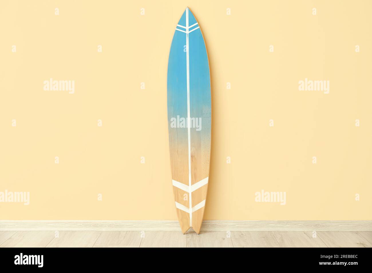 Wooden surfboard near beige wall Stock Photo - Alamy