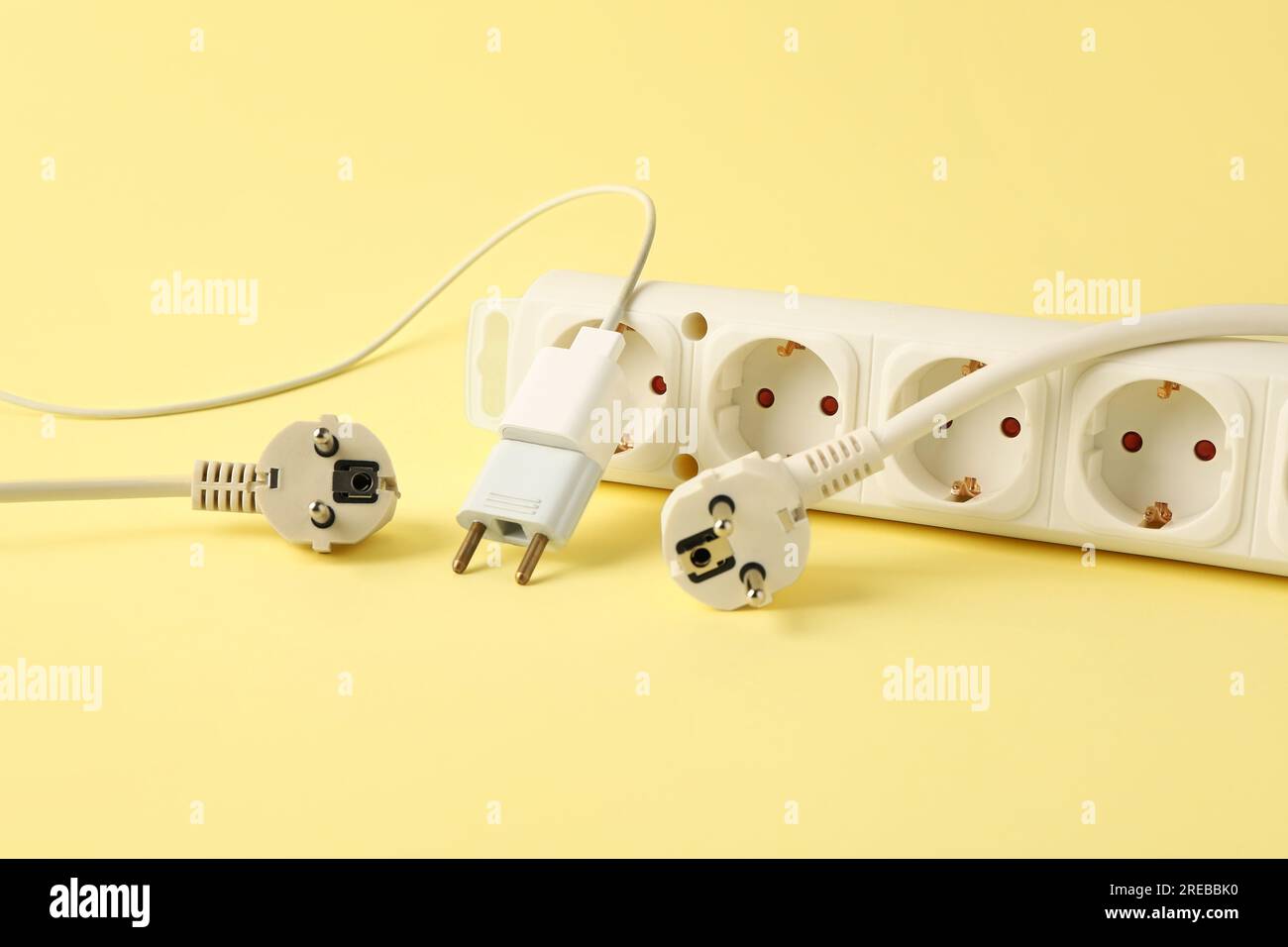 Power socket with plugs on yellow background. Electricity bill concept ...