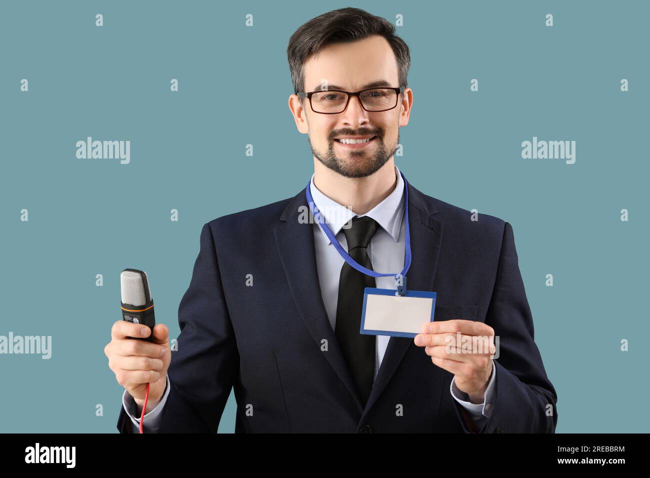 Male journalist with badge and microphone on blue background Stock ...