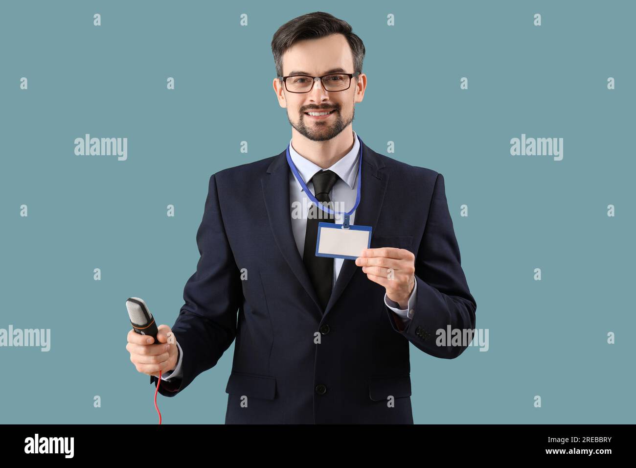 Male journalist with badge and microphone on blue background Stock ...
