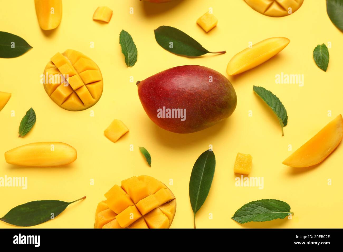 many fresh mangoes on yellow background Stock Photo - Alamy