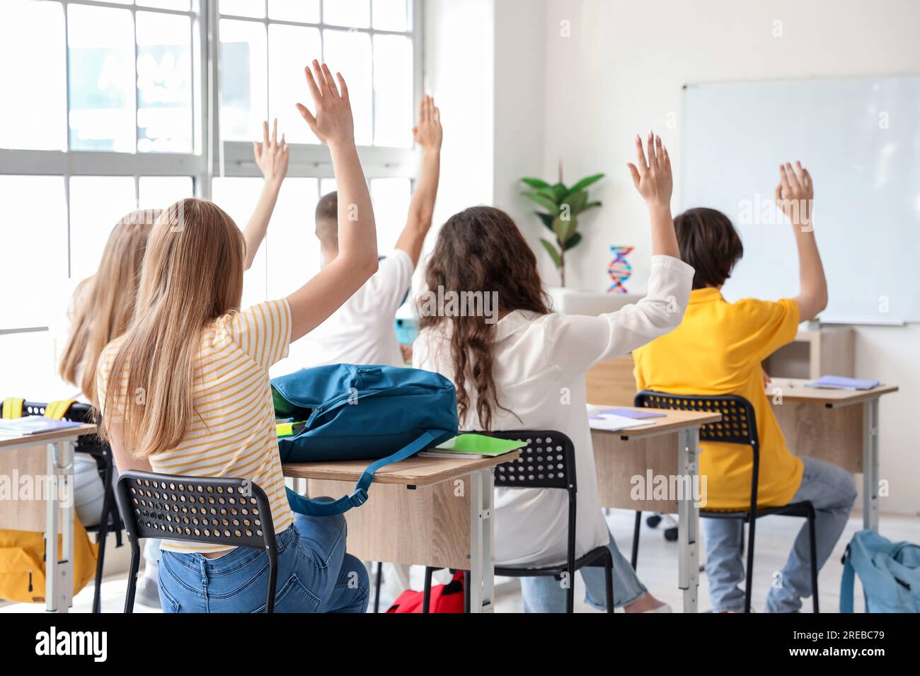 Group of students having lesson in classroom Stock Photo - Alamy