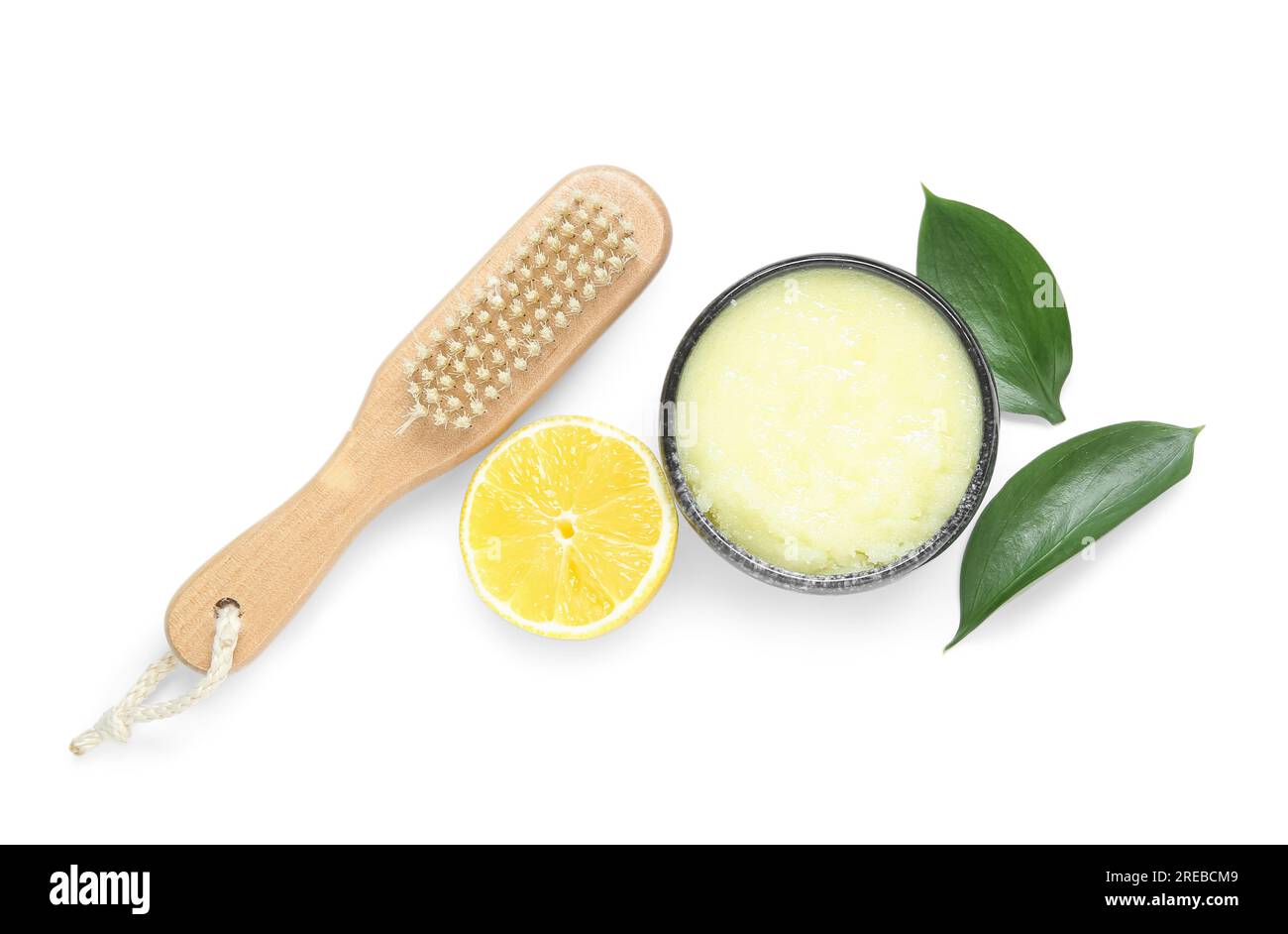 Bowl of lemon body scrub with massage brush isolated on white ...