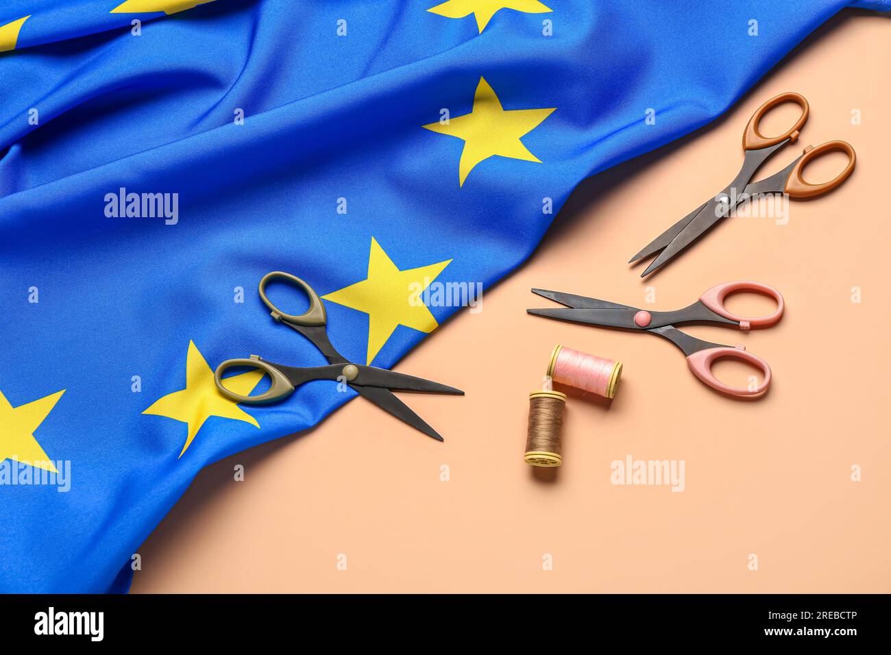 Scissors, threads and flag of European Union on beige background Stock ...