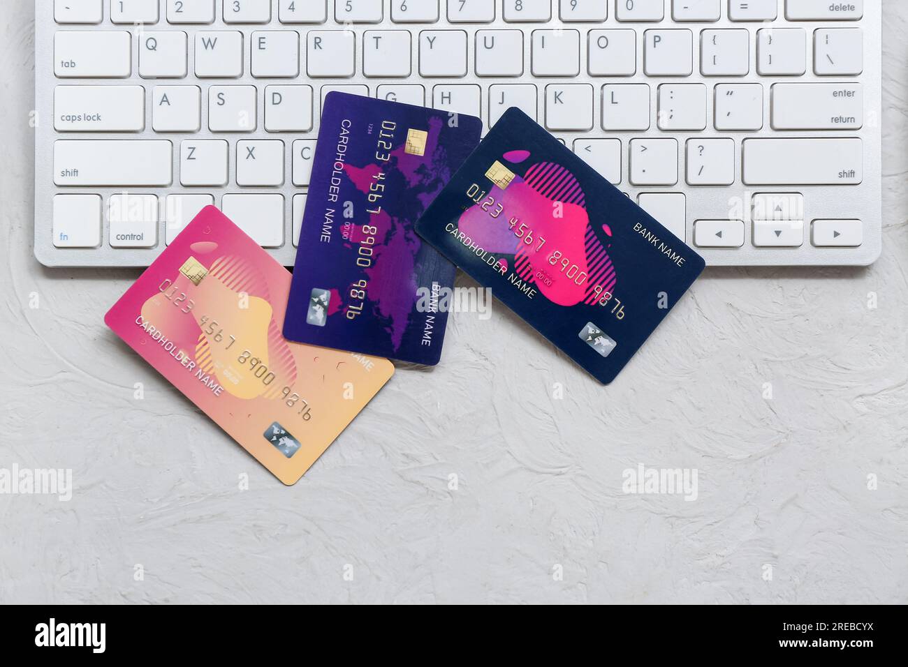 Keyboard with different credit cards on grunge grey background Stock ...