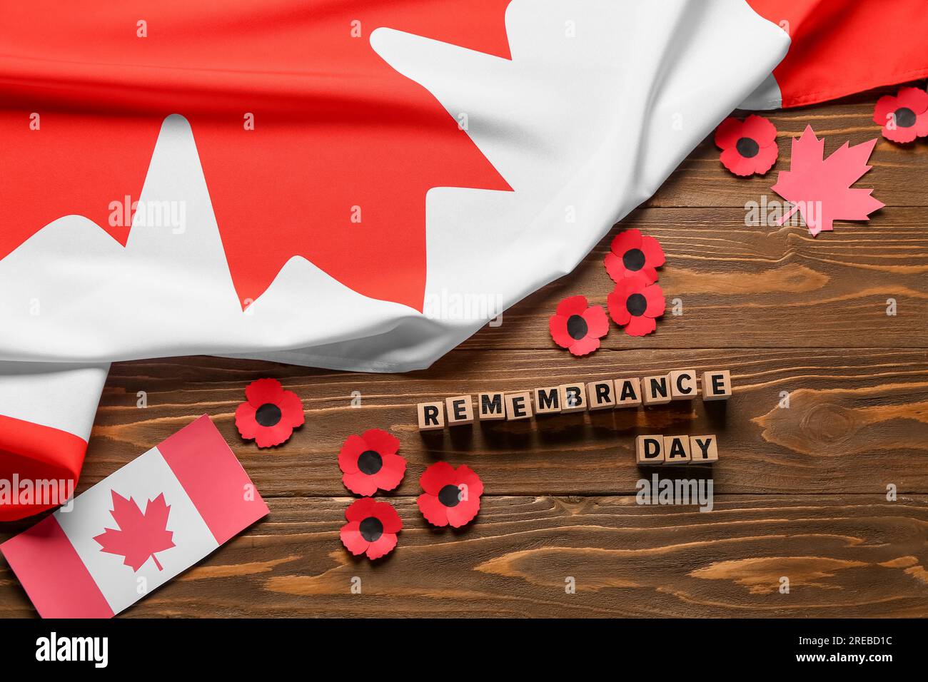 Poppy flowers with flags of Canada on wooden background. Remembrance ...
