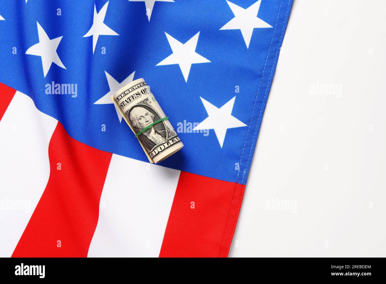 USA flag and roll of dollar banknotes on white background Stock Photo ...