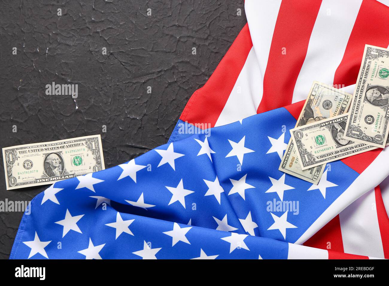 Flag of USA and dollar banknotes on black background Stock Photo - Alamy