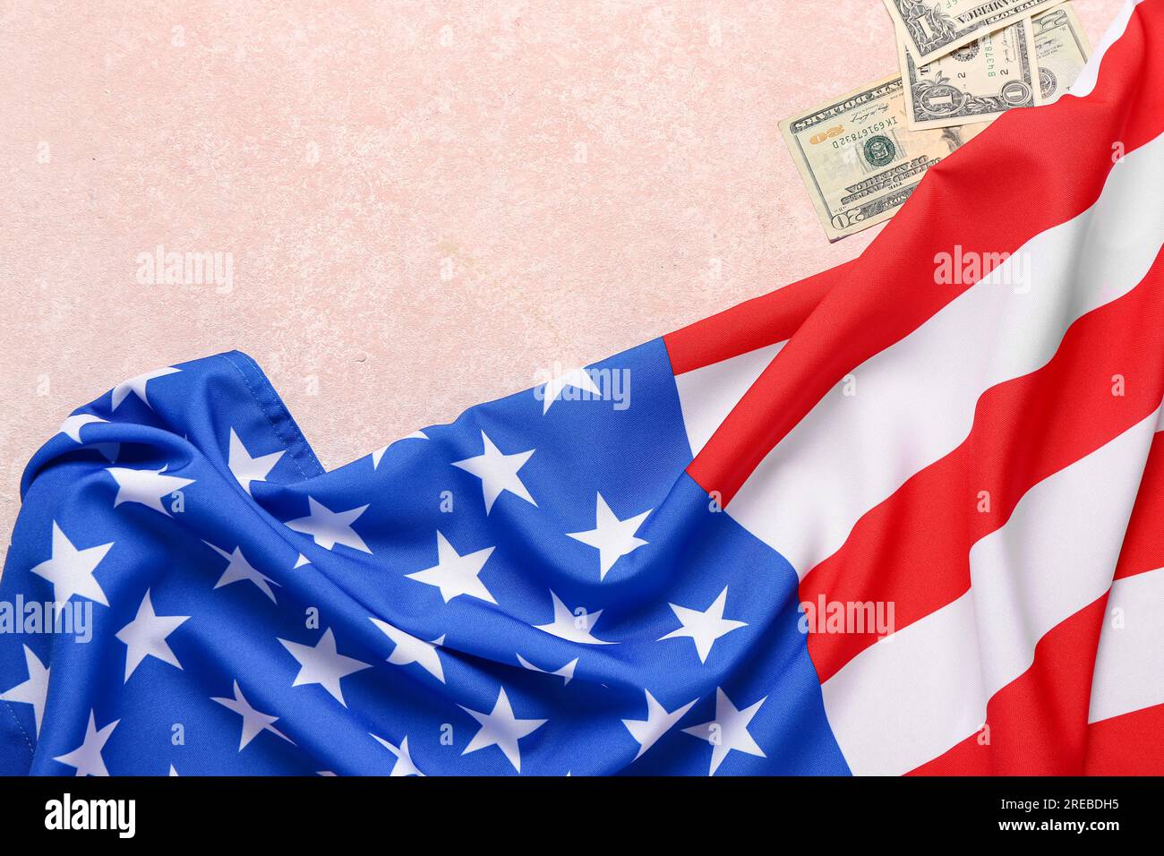 Flag of USA and dollar banknotes on beige background Stock Photo - Alamy