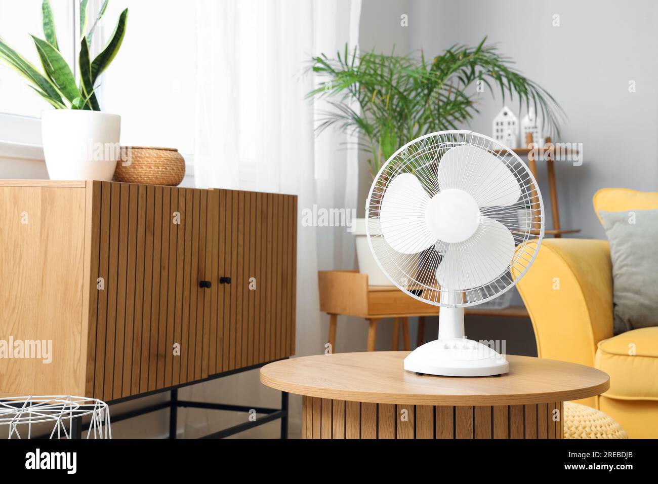 Electric fan on wooden coffee table in interior of living room Stock ...