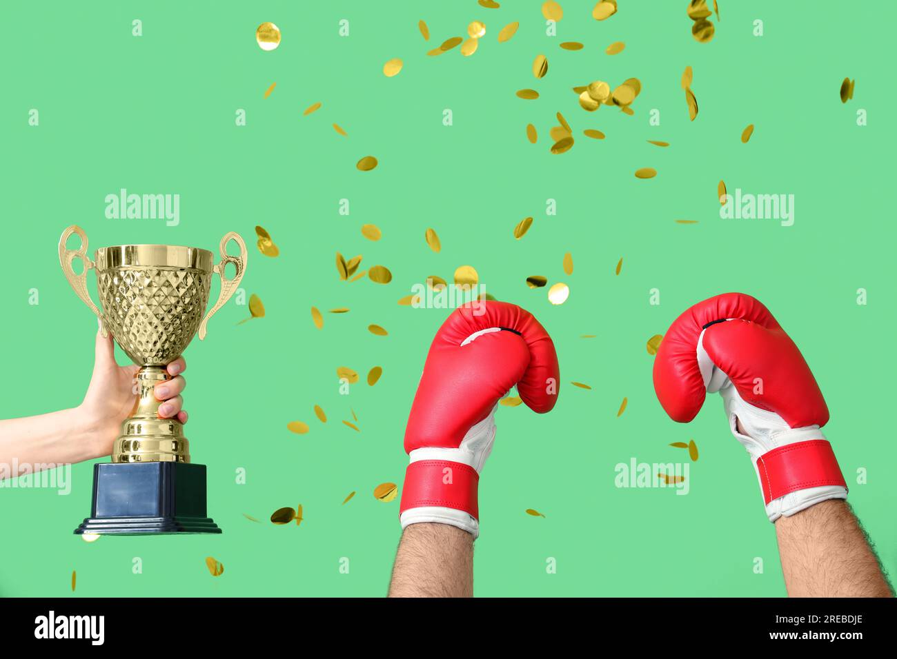 Female hand with gold cup, male hands in boxing gloves and confetti on ...