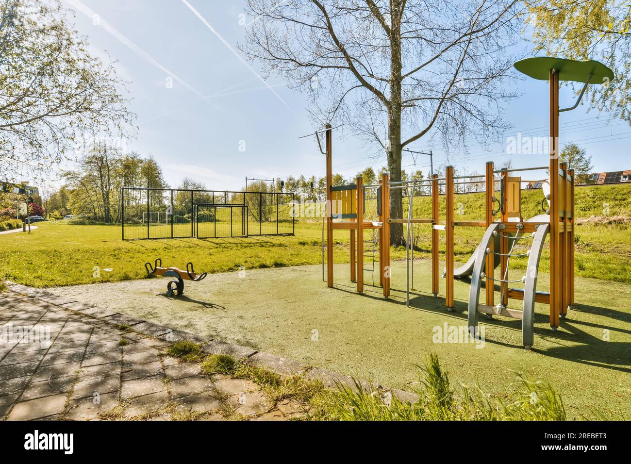 an outdoor play area with swings, slides and climbing equipment in the ...