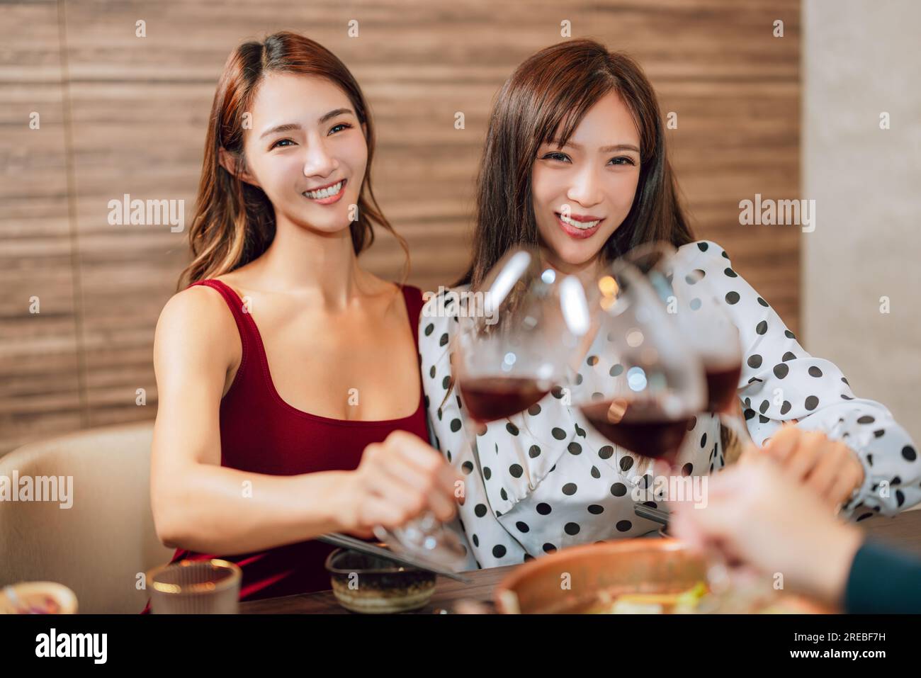 girlfriends raise a toast with glasses Stock Photo - Alamy