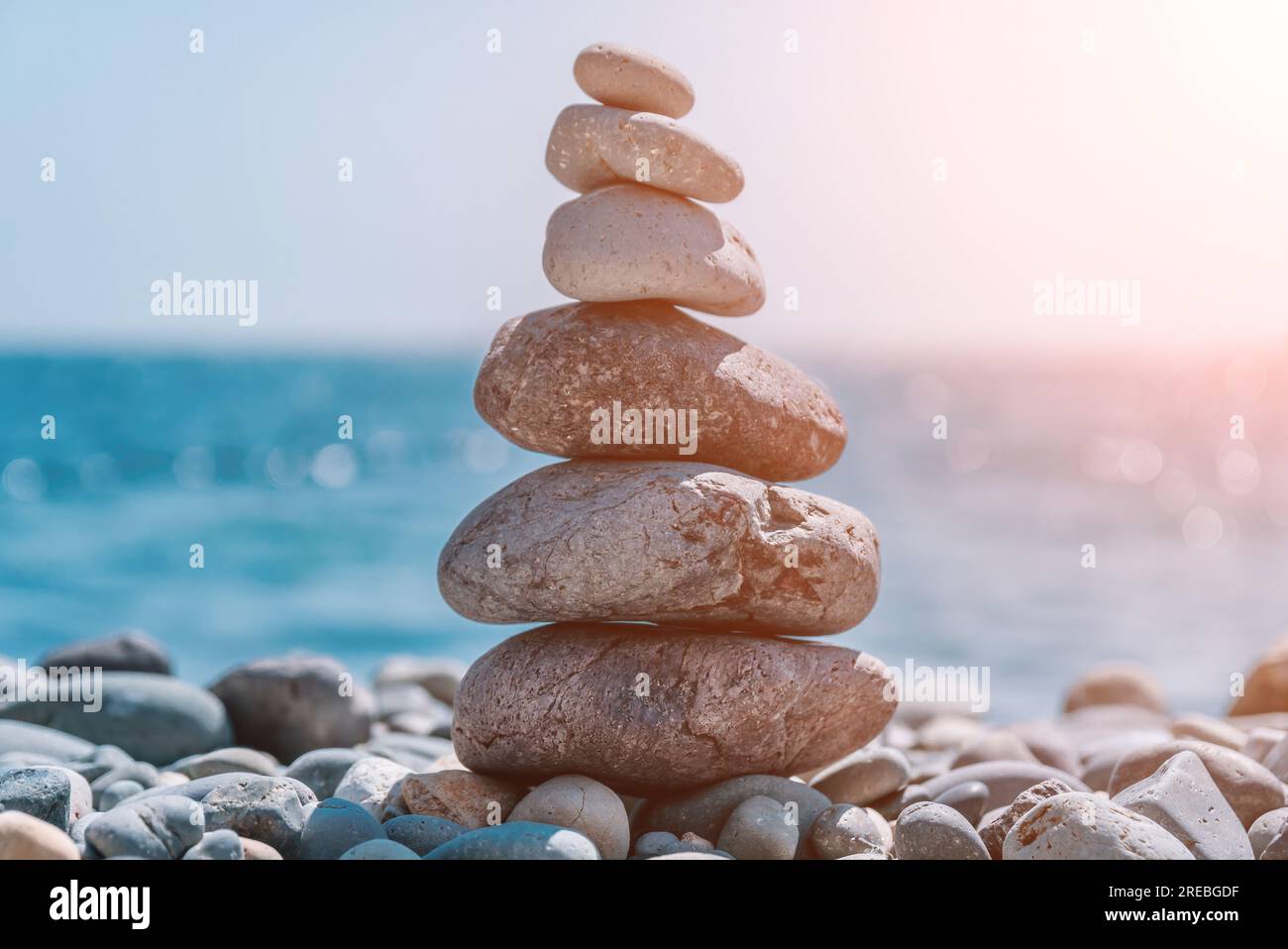 Balanced rock pyramid on sea pebbles beach, sunny day and clear sky at ...