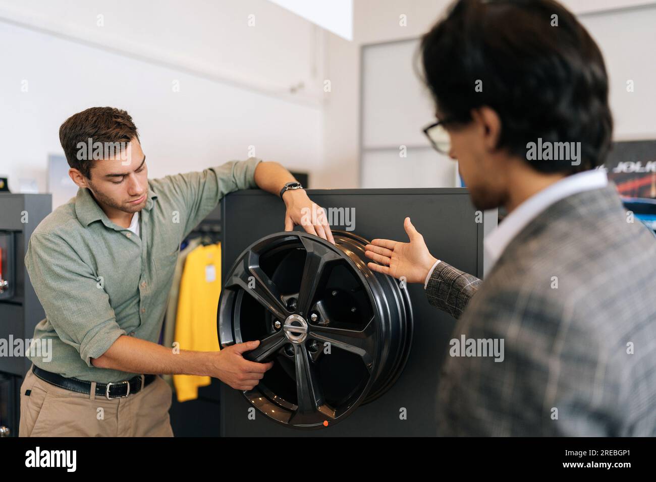 Back view of professional salesman in business suit talking about ...