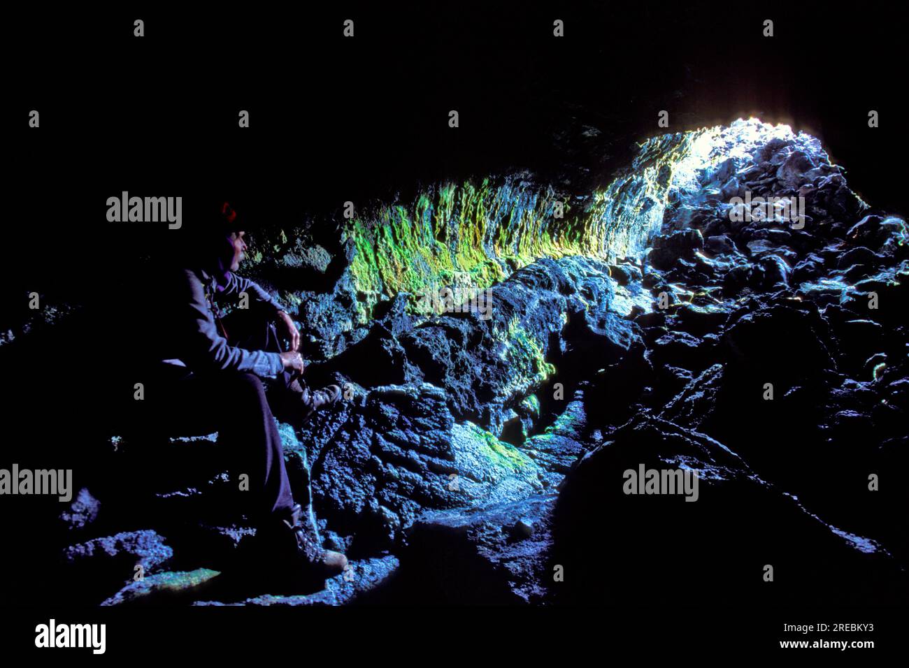 Man sitting insde Kazumura cave, the worlds longest lava tube, Puna ...