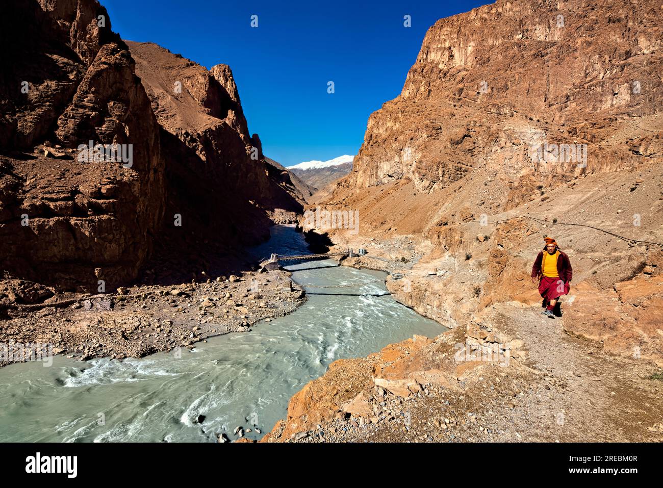 Monk walking along the Tsarab Chu River, Phugtal (Phuktal), Zanskar ...