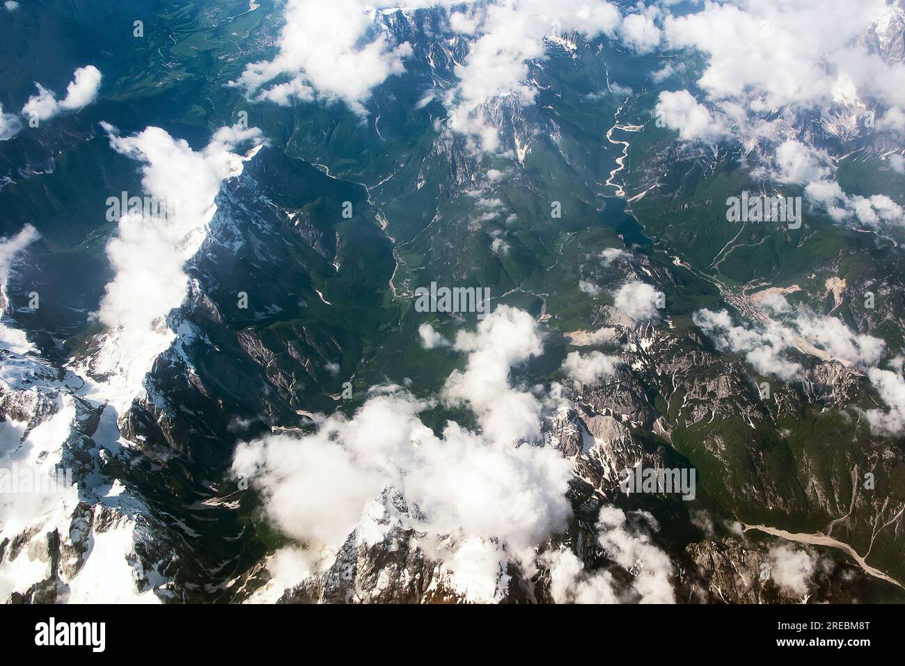 Beautiful window view of fluffy clouds and Alps mountains from ...