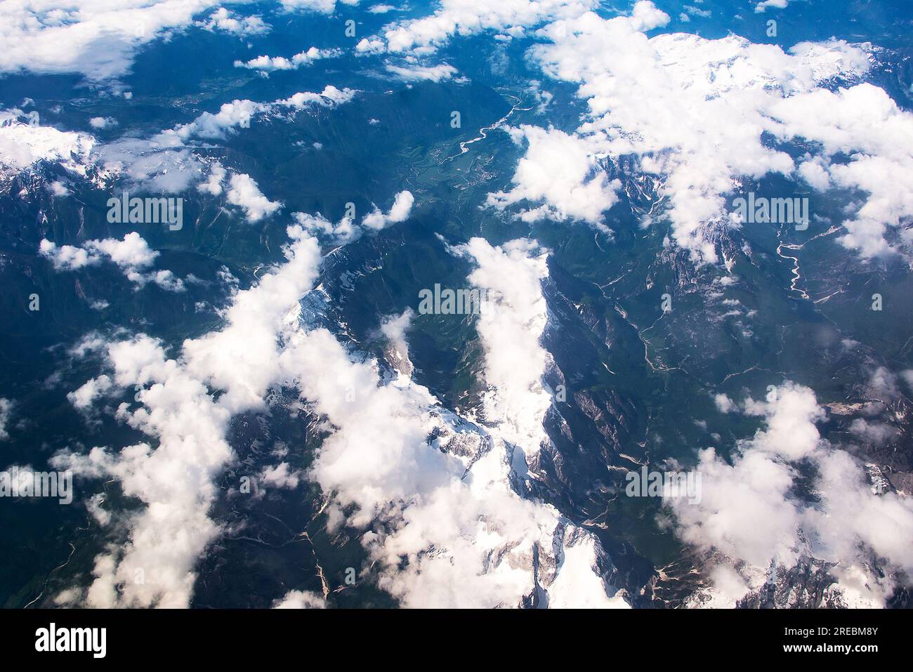 Beautiful window view of fluffy clouds and Alps mountains from ...