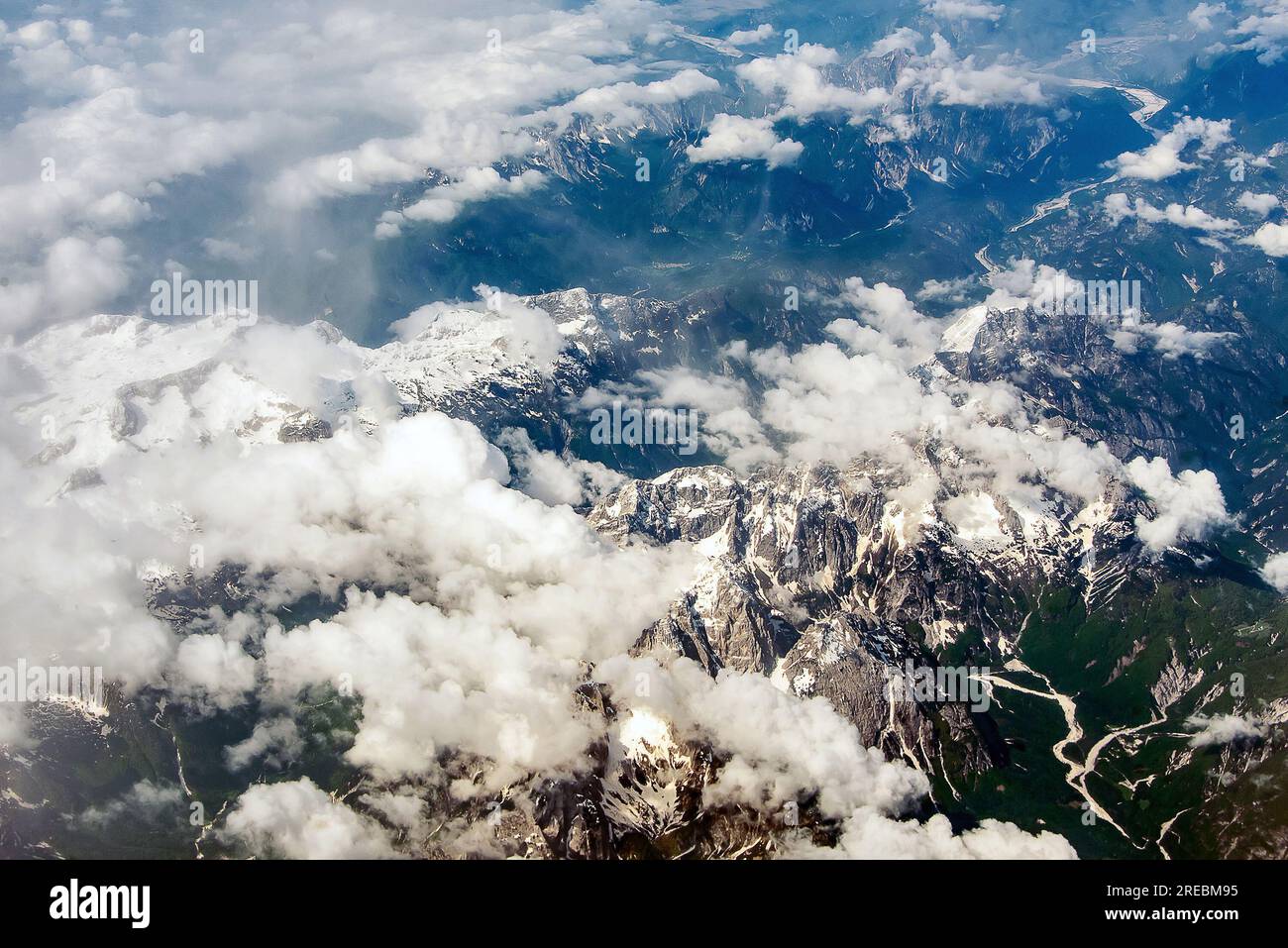 Beautiful window view of fluffy clouds and Alps mountains from ...
