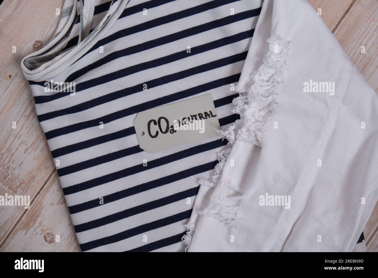 CO2 neutral emission text note on stack of clothes. Ecology nature ...